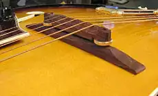 Fitting an archtop bridge, easily and accurately - StewMac