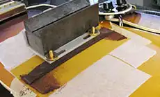 Fitting an archtop bridge, easily and accurately - StewMac