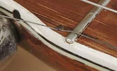 Setting up a banjo's 5th string: nut, capos and peg - StewMac