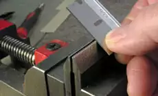 Hiding an "evil smile" peghead break with the Razor Blade Trick - StewMac