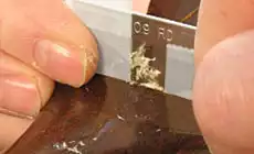 Hiding an "evil smile" peghead break with the Razor Blade Trick - StewMac