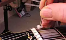 Putting the new Nut Slotting Gauge to work on a "burn victim" guitar ...