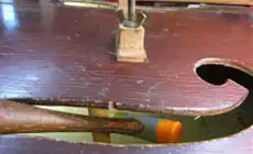 Regluing the bass bar inside a standup bass - StewMac