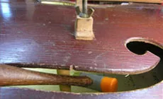 Regluing the bass bar inside a standup bass - StewMac