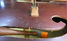 Regluing the bass bar inside a standup bass - StewMac