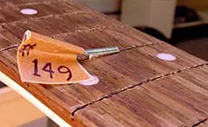 When frets don't fit the slot, resize the fret tang - StewMac