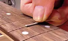 When frets don't fit the slot, resize the fret tang - StewMac