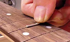 When frets don't fit the slot, resize the fret tang - StewMac